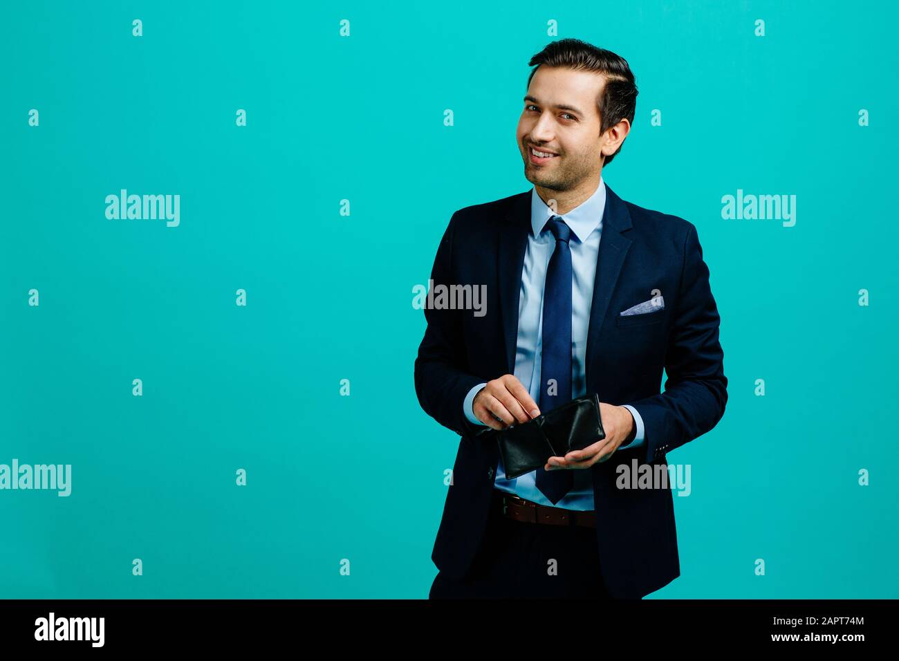 Portrait of a young entrepreneur business man pulling money from wallet ...