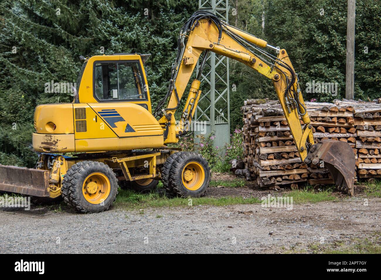 yellow excavator on construction site Stock Photo - Alamy