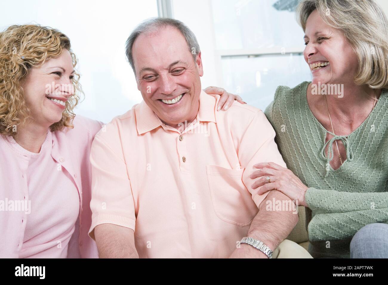 View of cheerful friends sitting together Stock Photo - Alamy