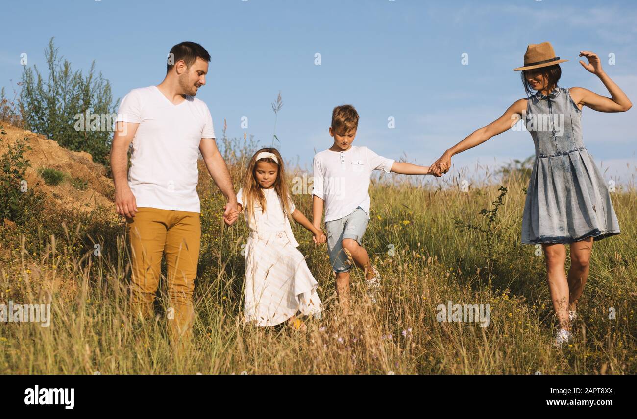 Happy young family spending time together outside in green nature Stock ...