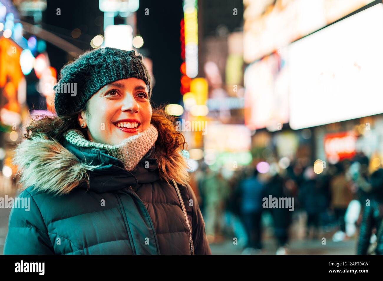 Amazed woman looking at the lights and the crowd in times square Stock ...