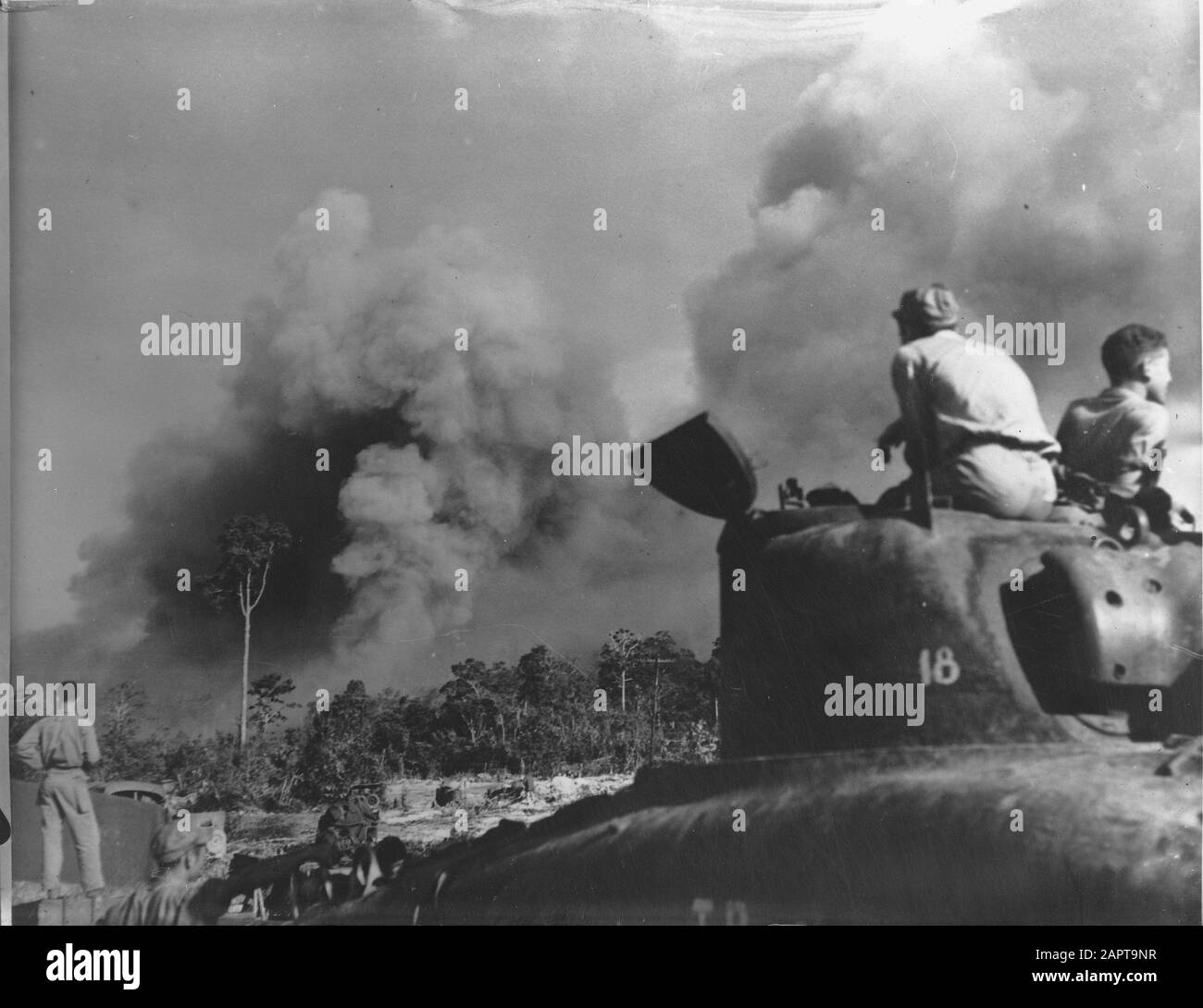 [Tank crew looks at fires in the distance] Annotation: Location Tarakan ...