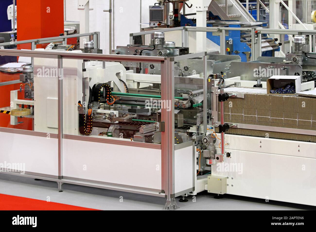 Carton packaging machine line in food factory Stock Photo - Alamy