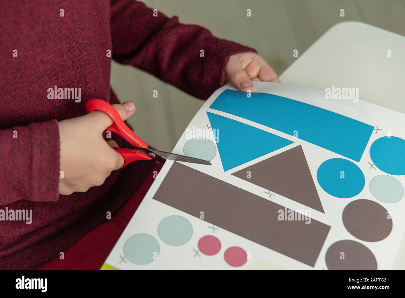 child cuts out details of application. Children at nursery school ...