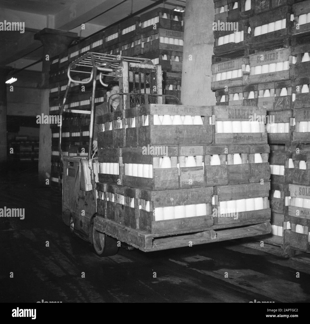 Milk factory in Denmark Lift truck with a pallet full of crates filled ...