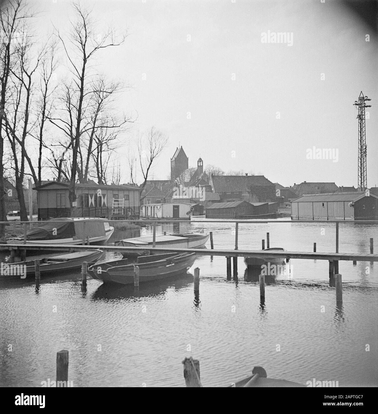 Friesland Port of Grouw with some boats: in the background the village ...