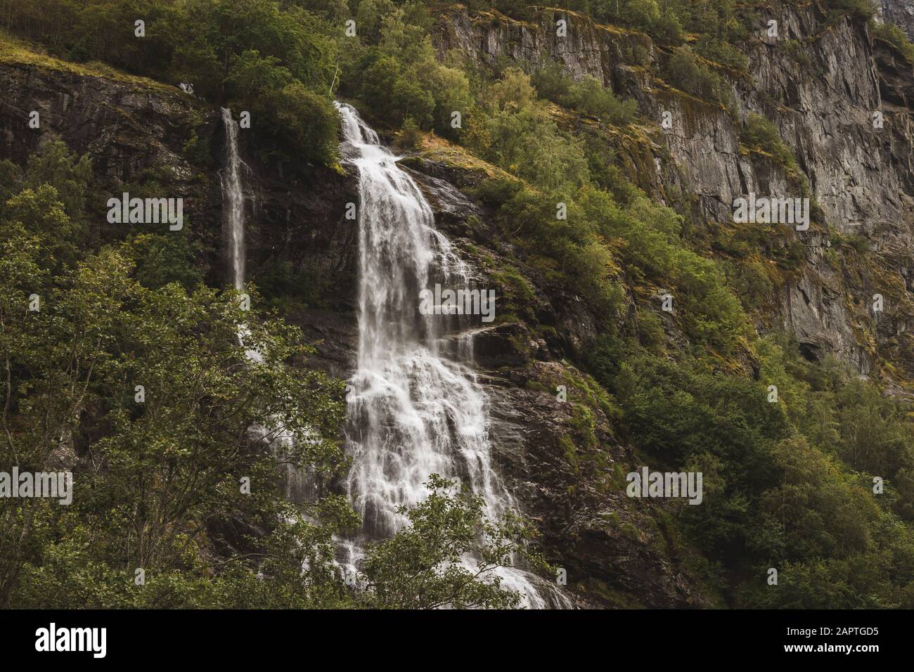 A big waterfall flowing down a rock face Stock Photo - Alamy