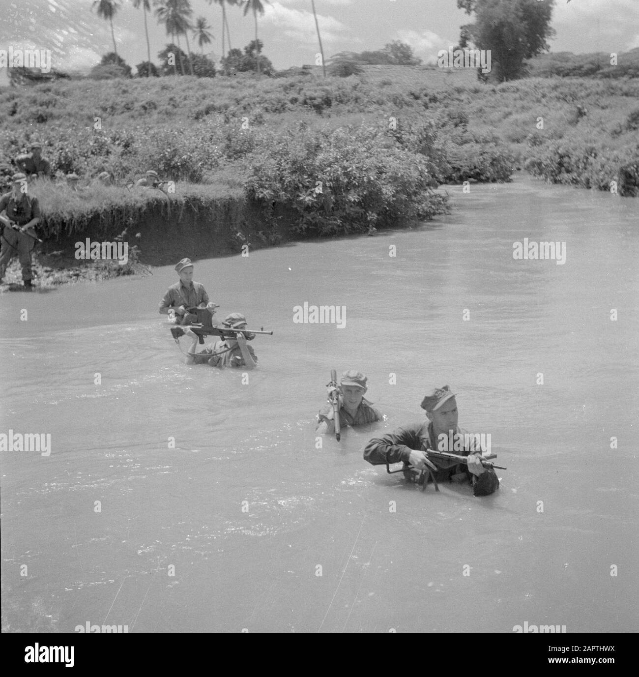 War volunteers in Malacca and Indonesia Wading a kali during a military ...