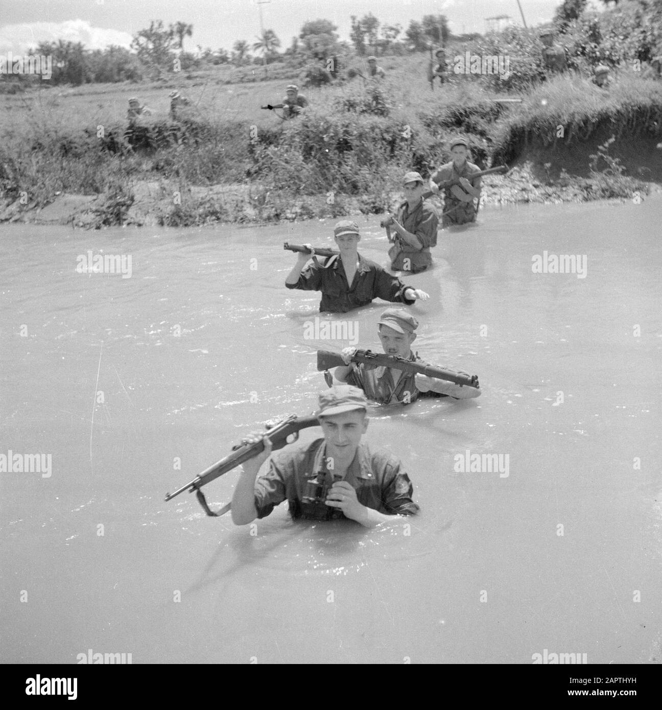 War volunteers in Malacca and Indonesia Wading a kali during a patrol ...