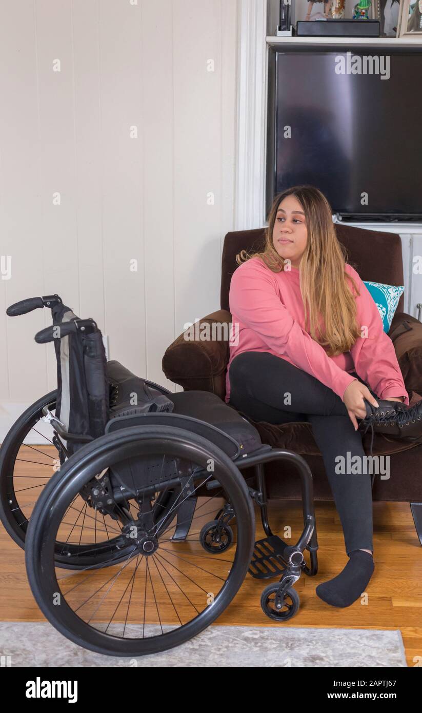 Woman with Spinal Cord Injury putting on shoes Stock Photo - Alamy