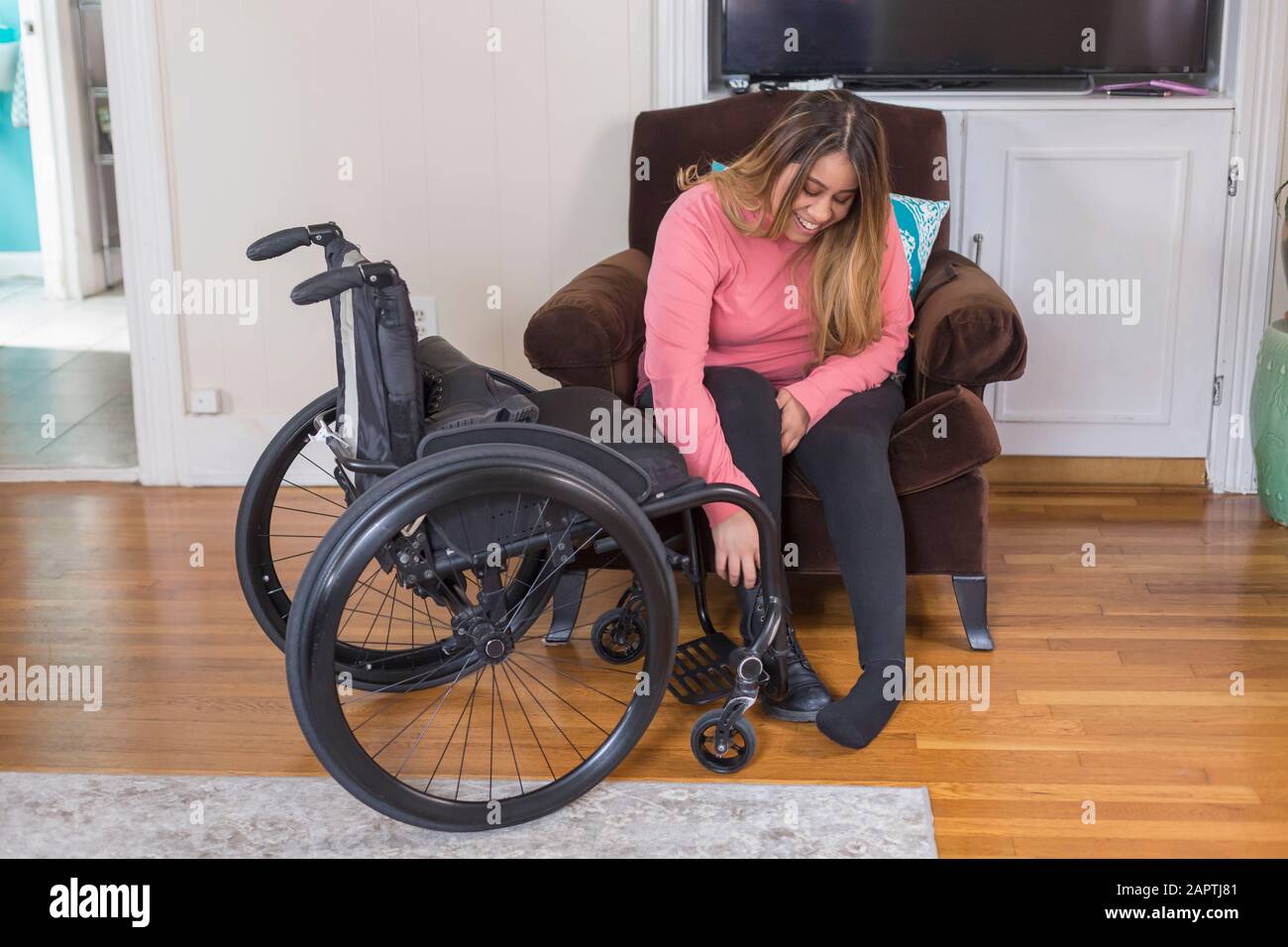 Woman with Spinal Cord Injury putting on shoes Stock Photo - Alamy