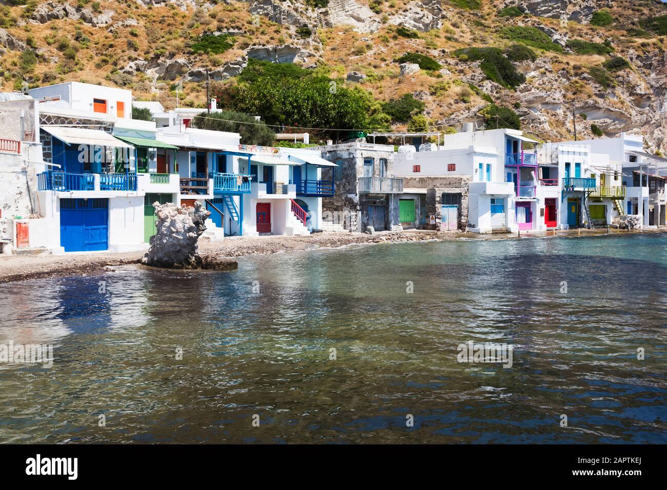 Klima village with white houses and colourful accents along the water's ...