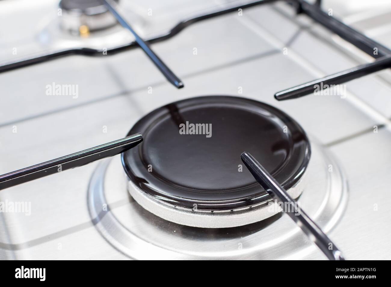 Close up shot of rapid burner on stainless steel gas hob with thin bar ...