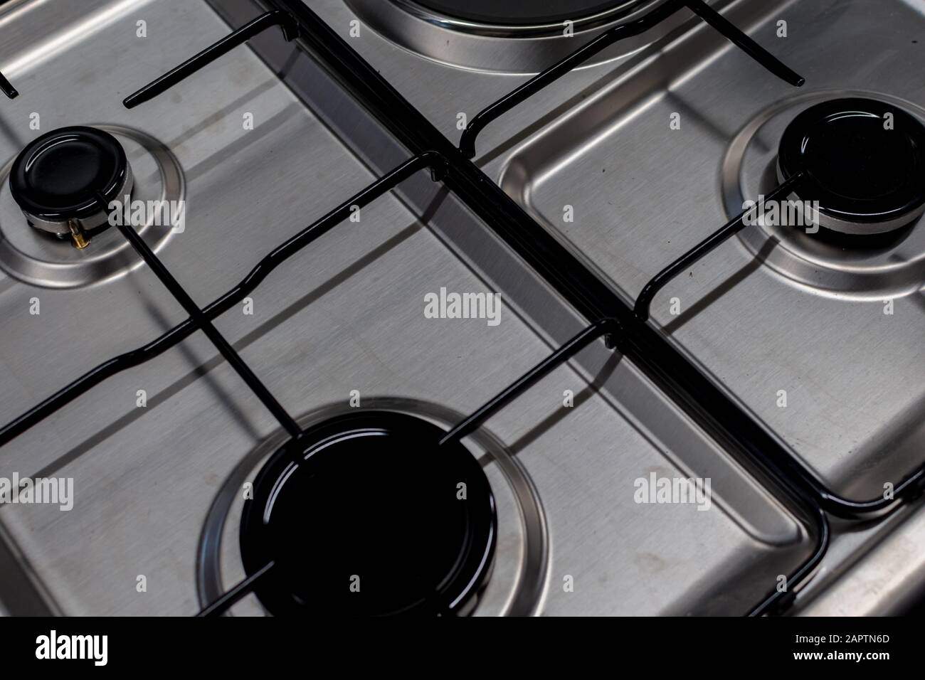Close up shot of rapid burner on stainless steel gas hob with thin bar ...