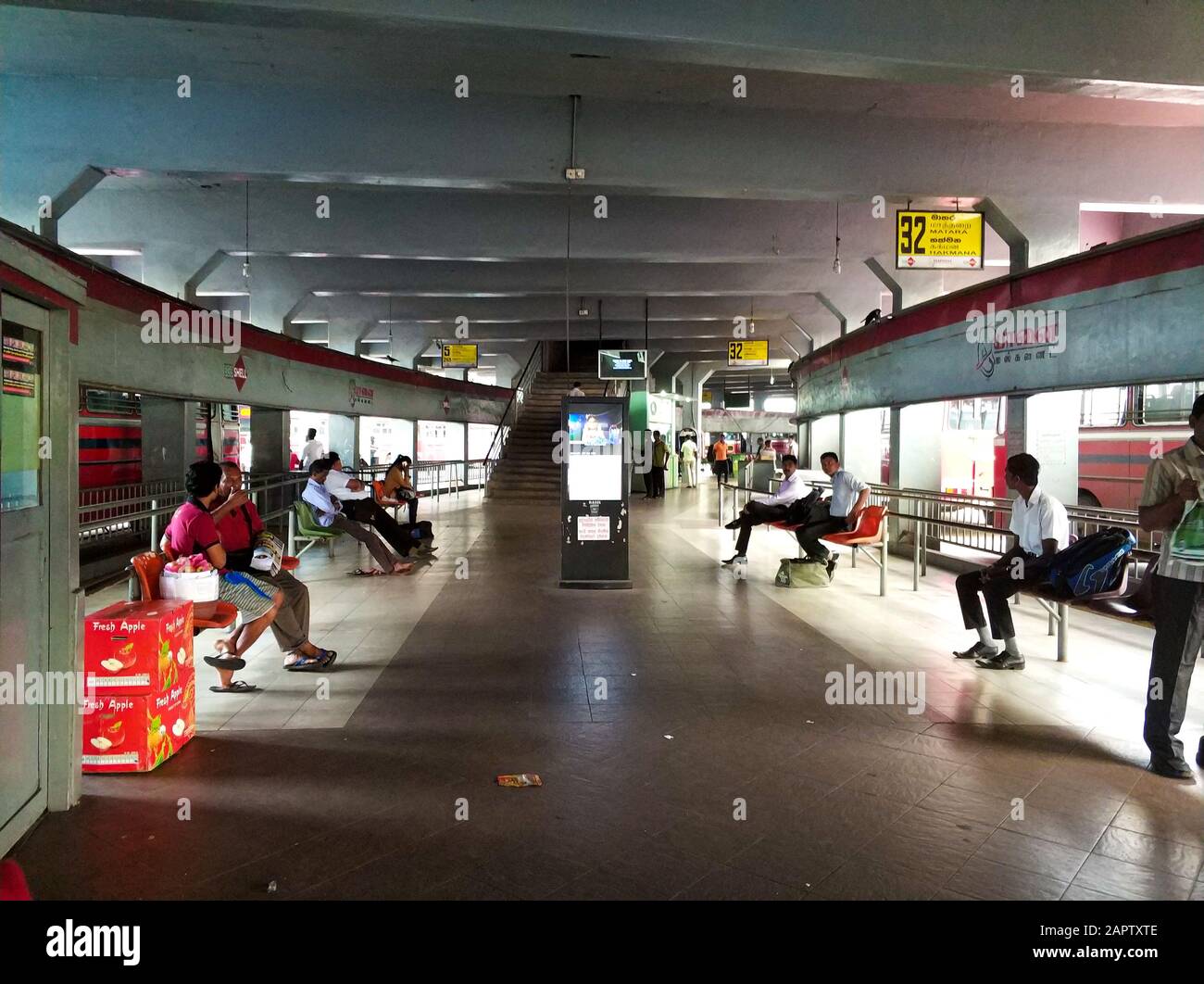 Bus station in Sri Lanka. People on benches are waiting for a bus ...