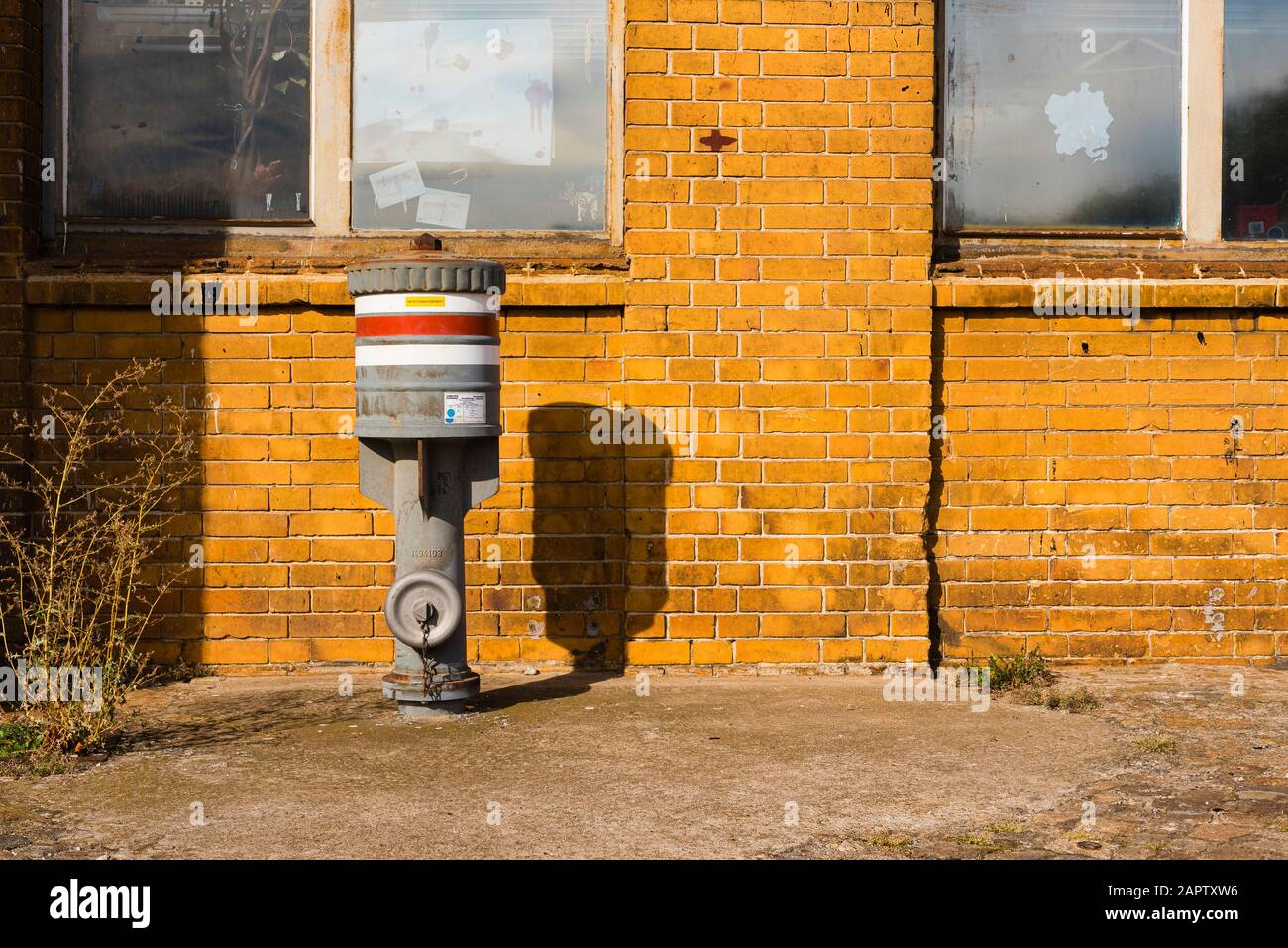 Old water hydrant, fire brigade hydrant, disused, brick wall in the ...