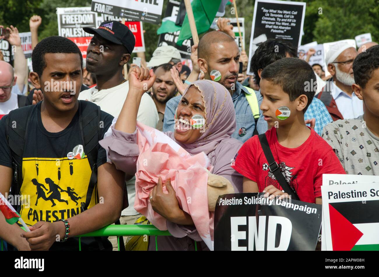 Palestinian supporters marching with flags, banners and placards ...