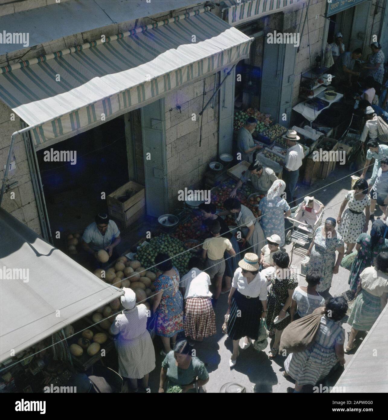 Jerusalem. Market table: in a narrow street with shops on both sides ...