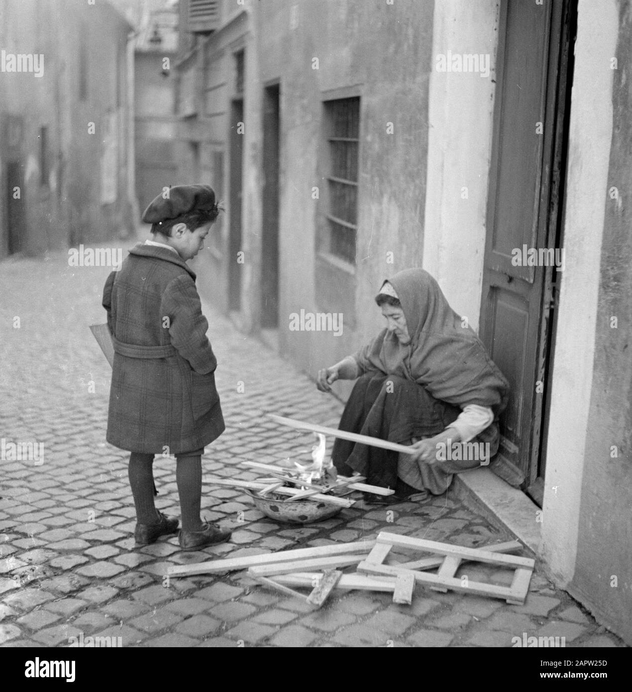 Rome: Visit to the city Boy watching an old woman make a fire Date ...