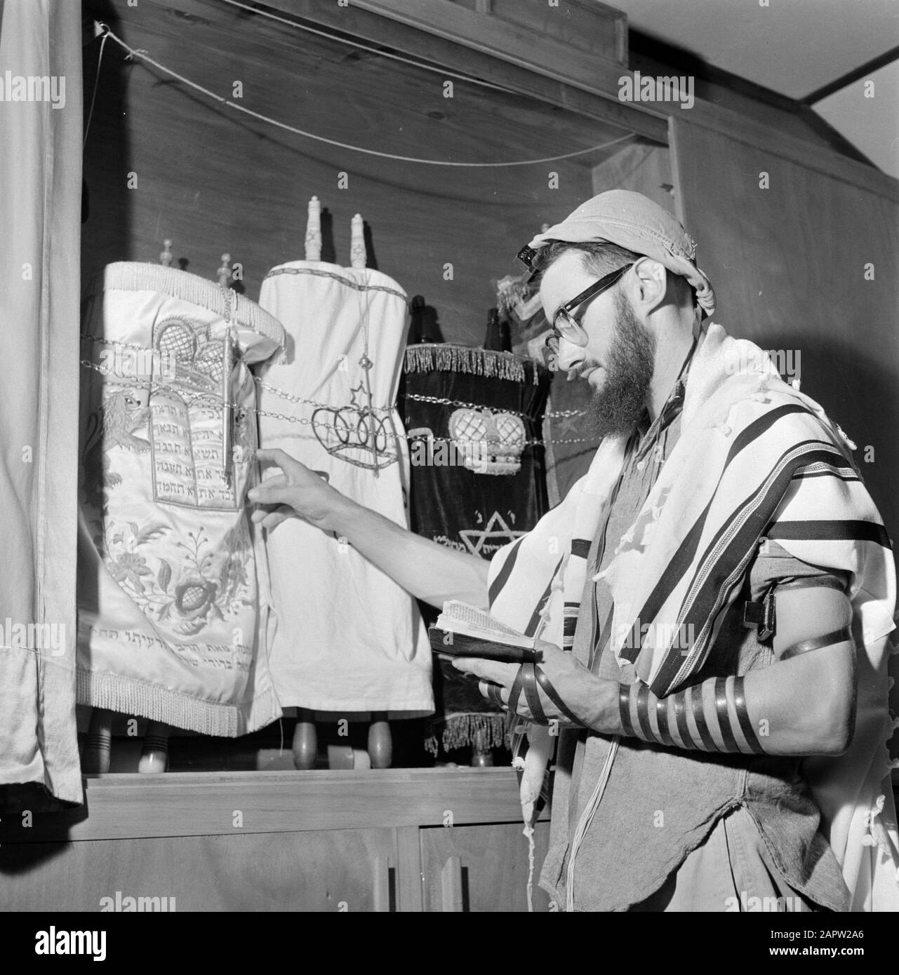 Jewish man with a hat on, a prayer cloak on and fitted with prayer ...