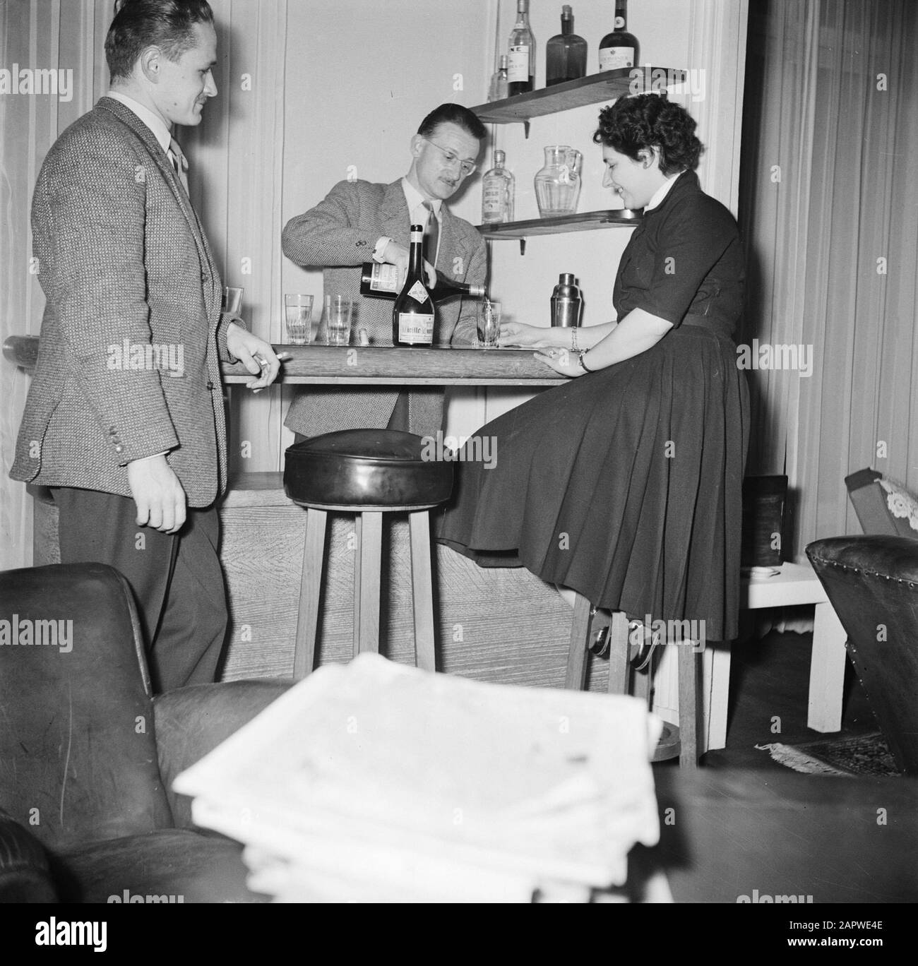 Residents of an apartment building in Paris Man behind his house bar ...