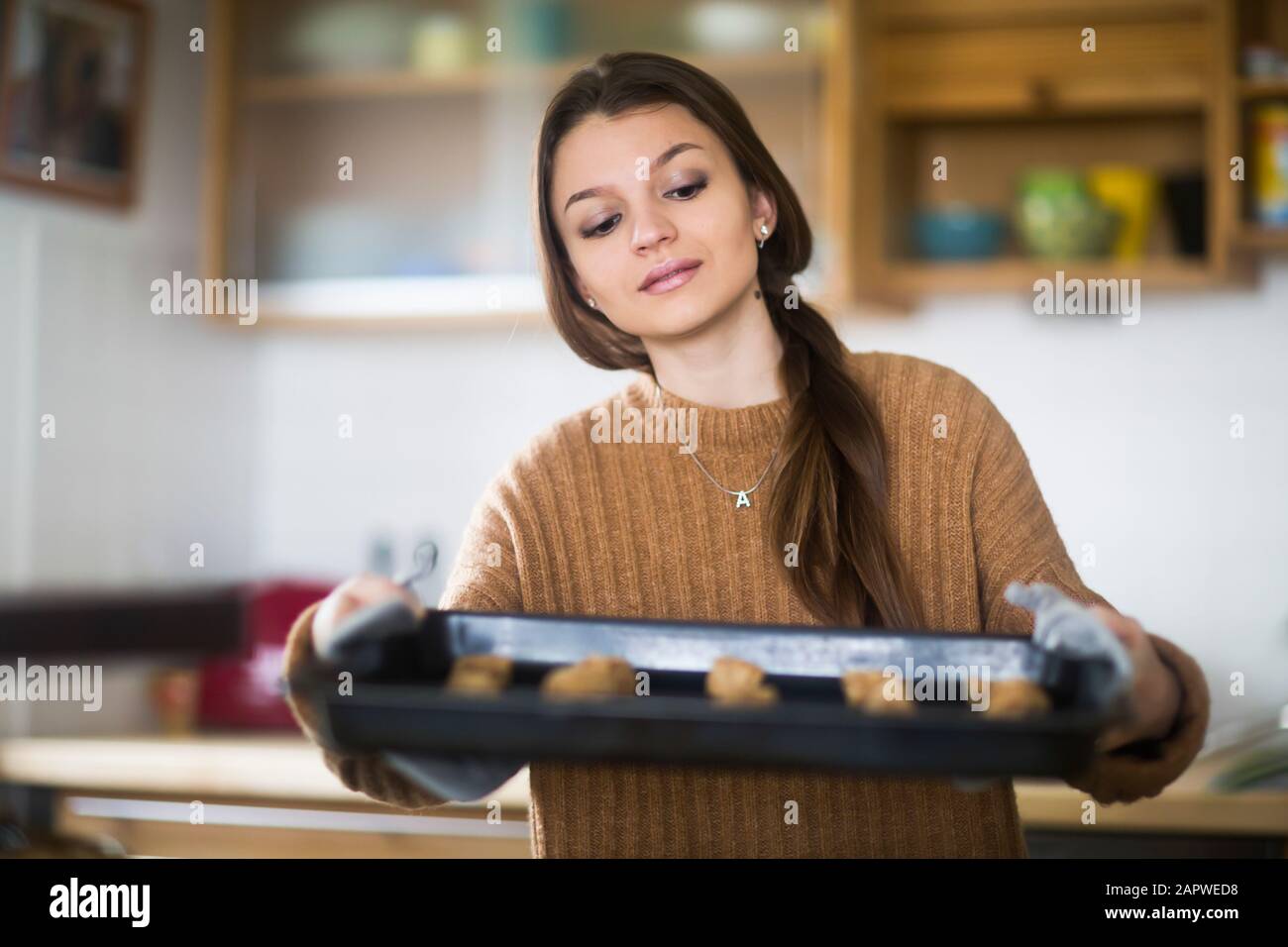 Young woman baking cookies in hi-res stock photography and images - Alamy