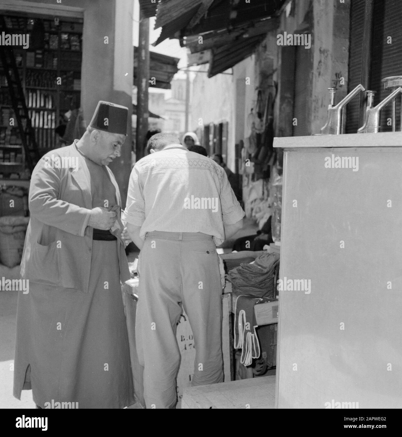 Israel: Nazareth Man with a fez on in conversation with a merchant Date ...