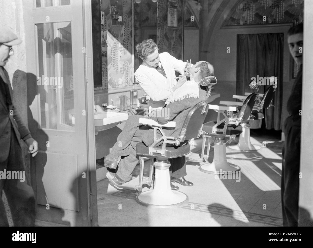 Rome: Visit to the city Man is shaved by a barber while two men watch ...