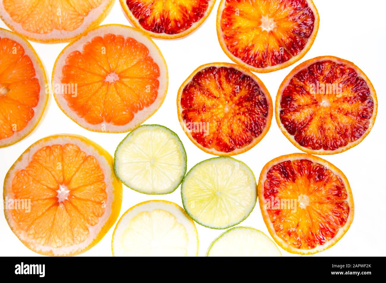 Slices of citrus cut rounds on white background Stock Photo - Alamy