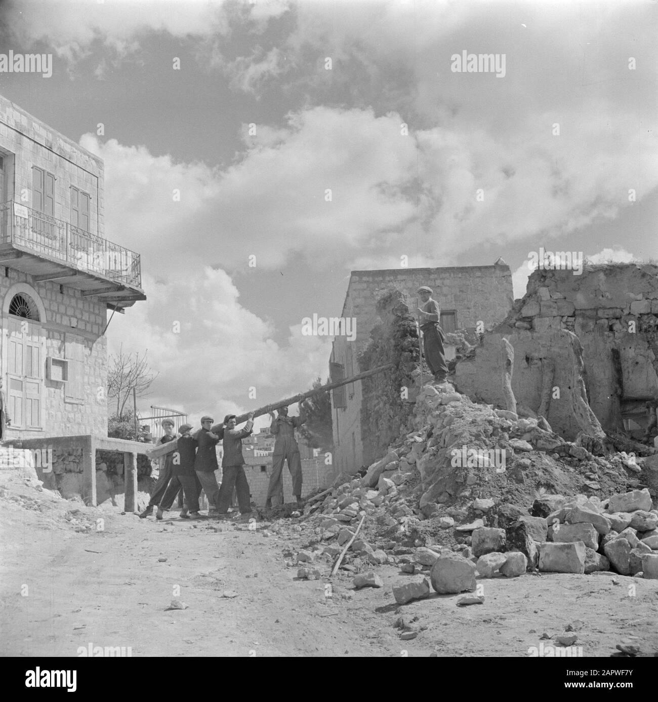 Israel 1948-1949 Men in a village demolishing a wall of a destroyed ...