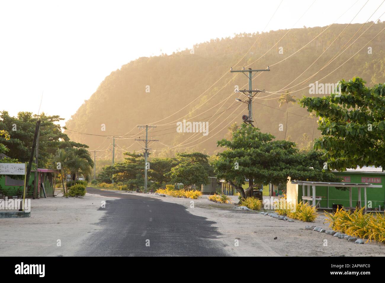 Samoan road crossing small village during golden hour in Samoa Stock ...