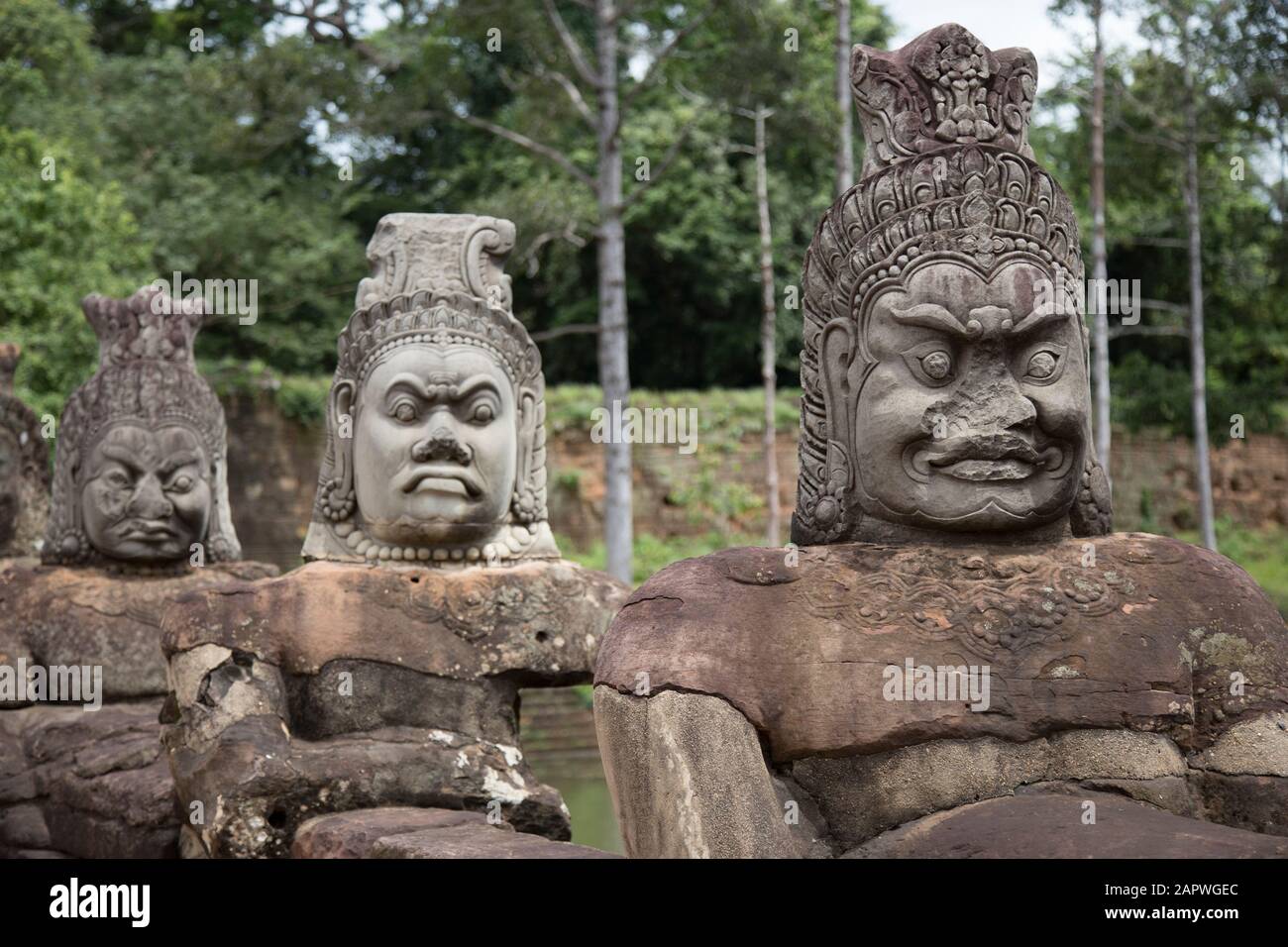 Three rock warrior statues on bridge located in Angkor Stock Photo - Alamy