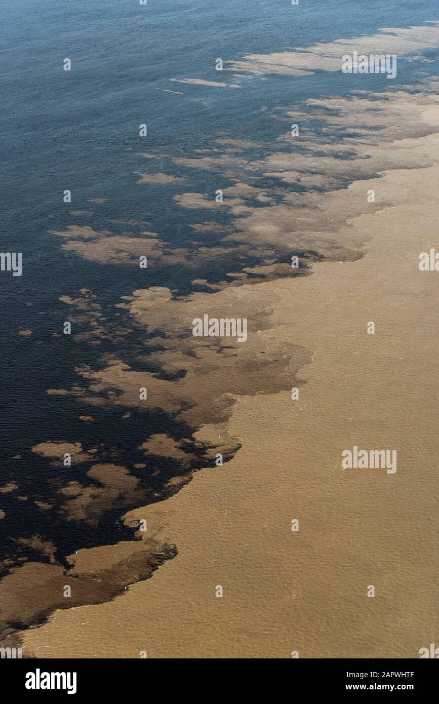 Aerial view to the meeting of muddy and dark waters in Amazon River ...