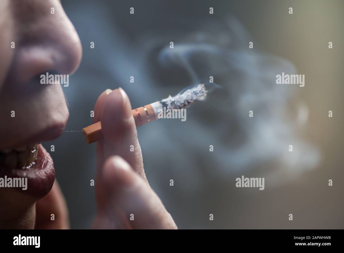 Closeup shot of a Chinese female smoking a cigarette Stock Photo - Alamy
