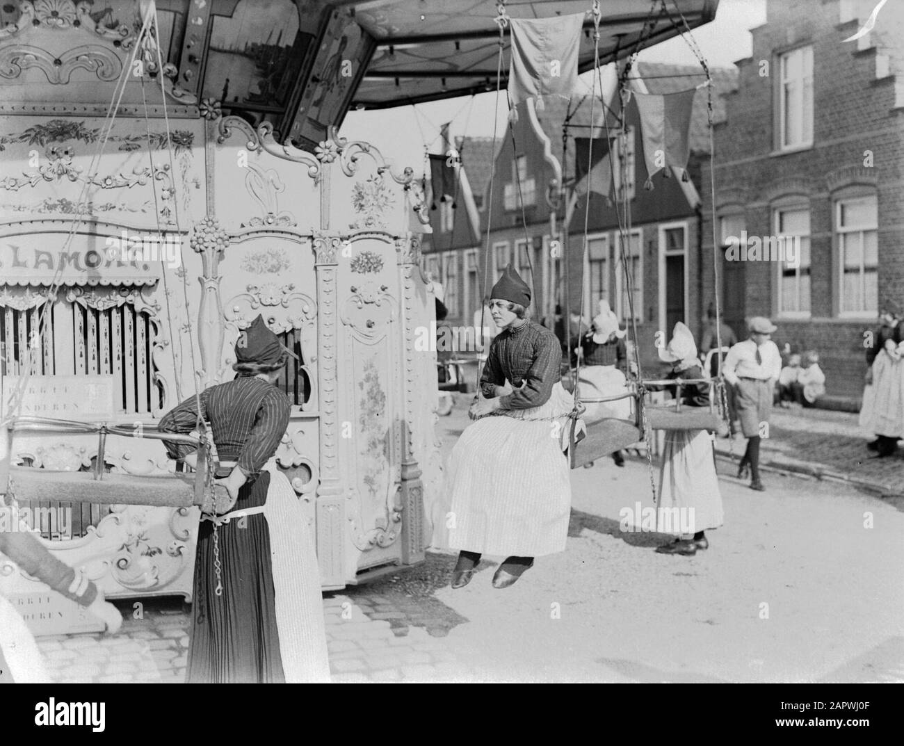Fair in Volendam Girls in traditional costume on a glider mill Date ...
