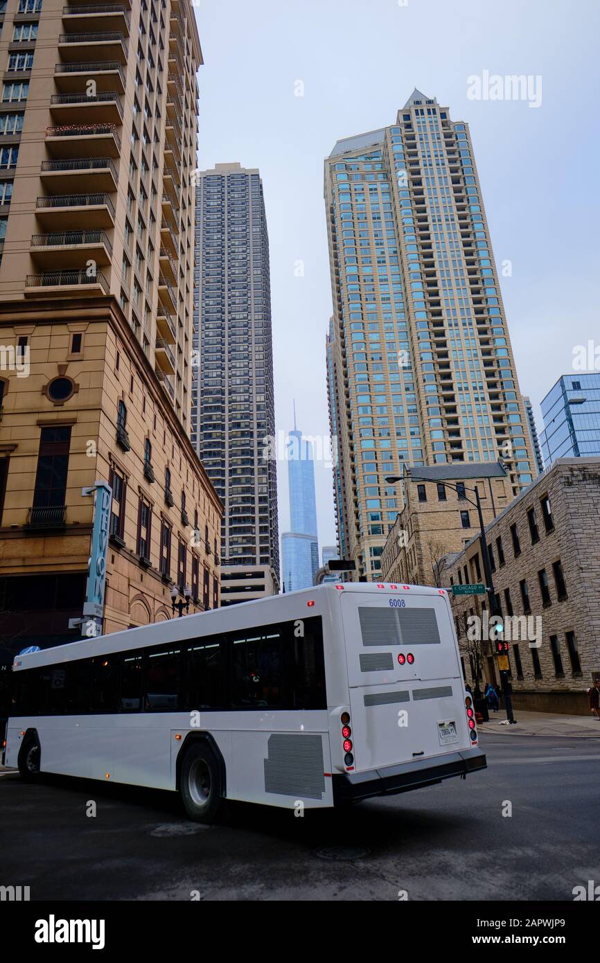 Vertical shot of modern skyscrapers and a white bus Stock Photo - Alamy