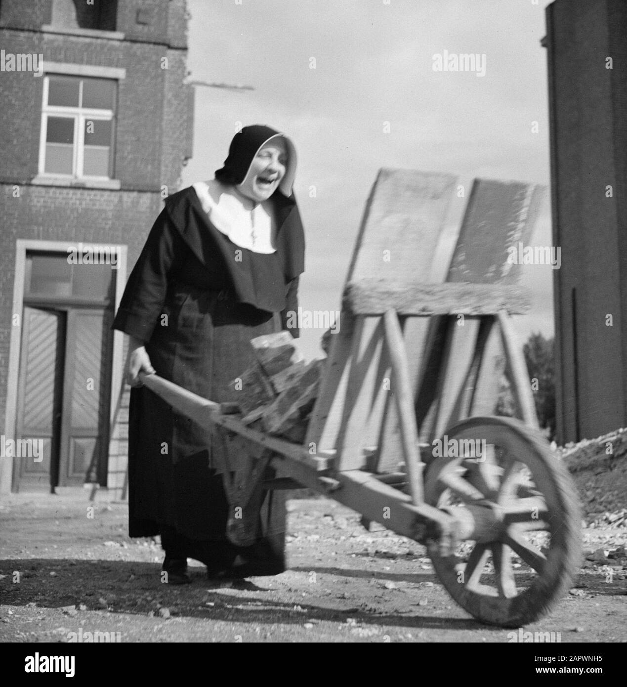 Rebuilding of a nunnery Mother Superior with wheelbarrow Date: 1940 ...