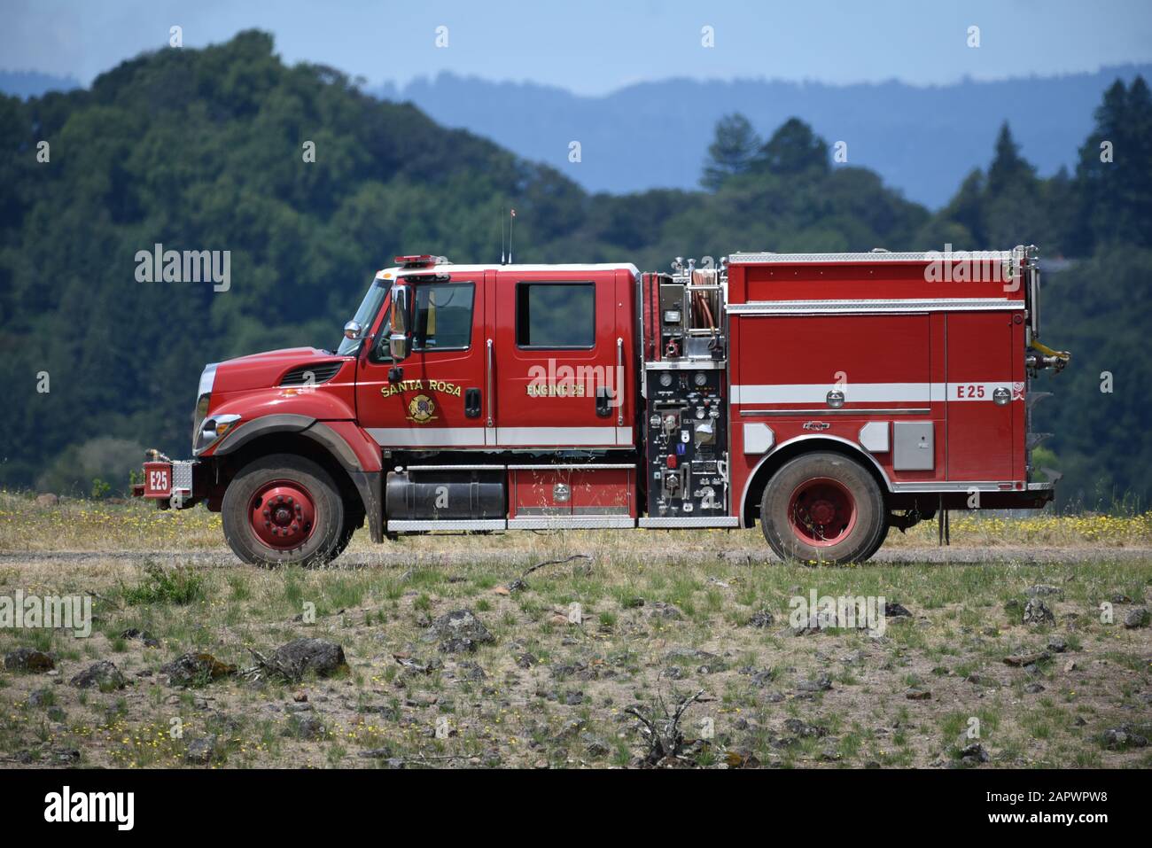 Side of a fire truck parked in the middle of a road in the countryside ...
