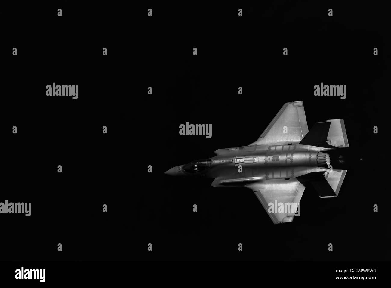 Closeup of a fighter jet pirouetting in the night sky Stock Photo - Alamy