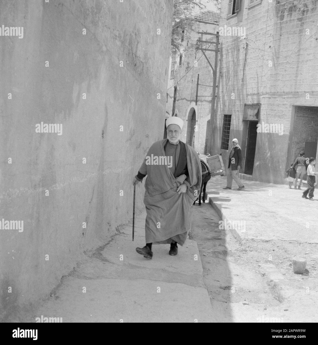 Israel: Nazareth Nazareth. Man in long robe, with headgear and walking ...