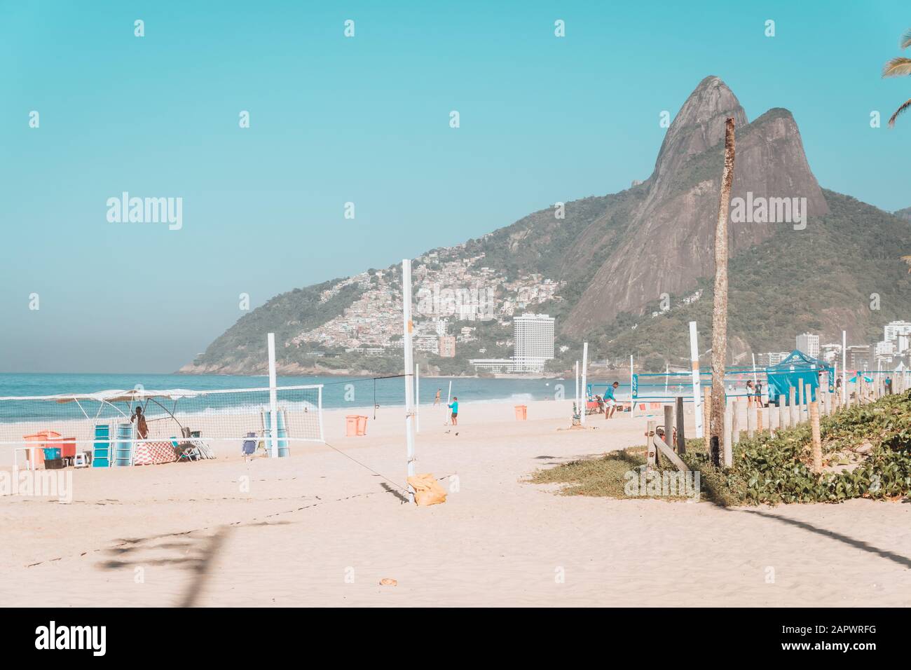Beach surrounded by the sea and rocks covered in greenery in Rio de ...