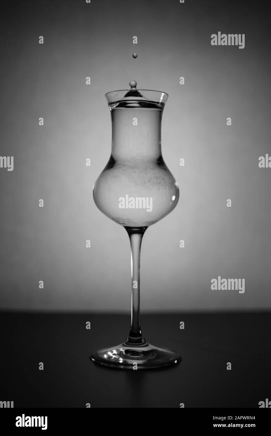 Vertical grayscale shot of a filled cocktail glass Stock Photo - Alamy