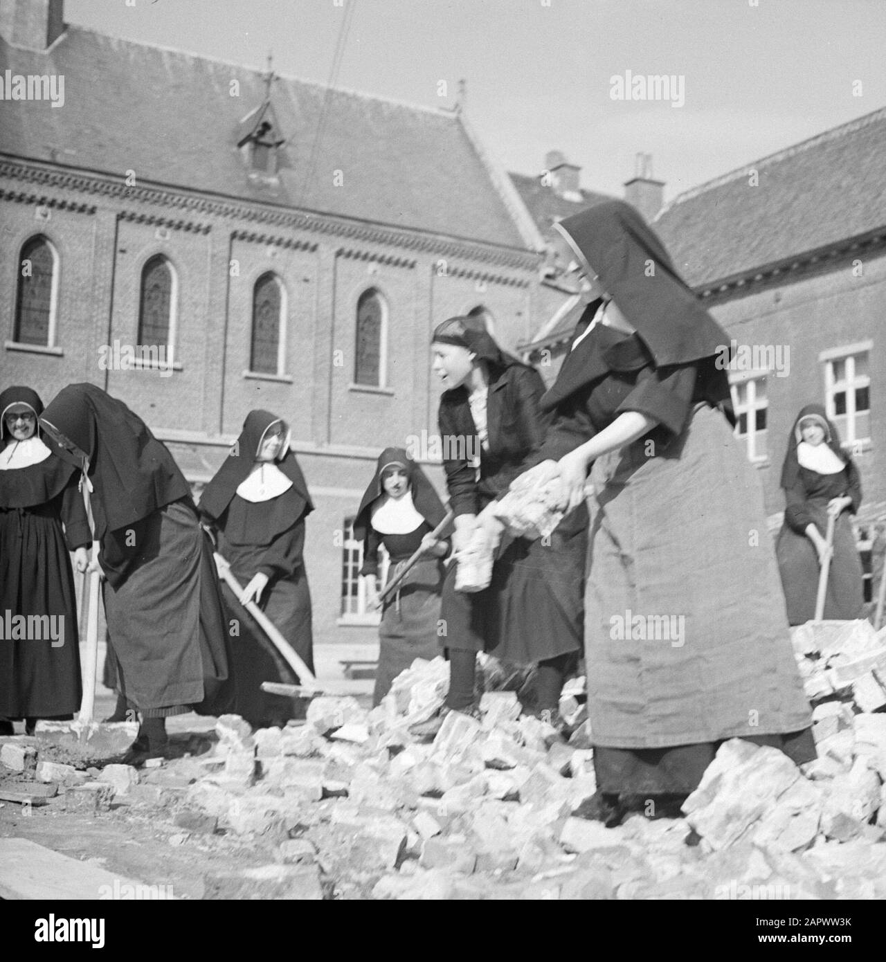 Rebuilding of a nunnery Nuns cleaning old debris Date: 1940 Location ...