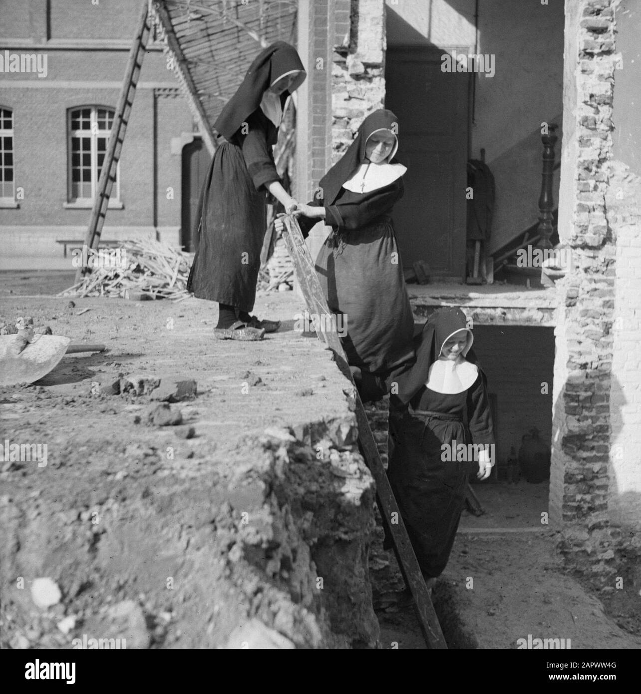 Rebuilding of a nunnery Nuns on ladder against embankment of cellar ...