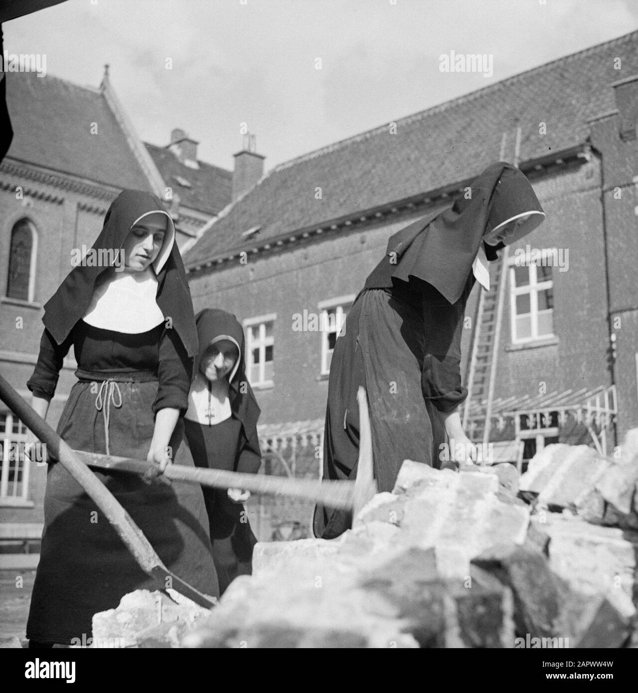 Rebuilding a nunnery Nuns working with picks Date: 1940 Location ...