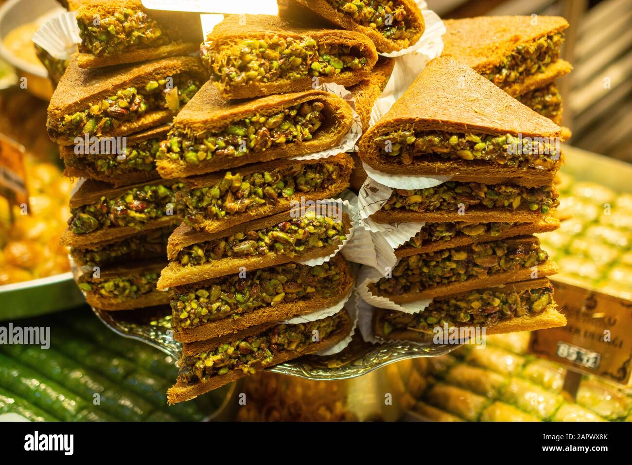 Turkish traditional dessert Kadayif baked in syrup served with nut ...