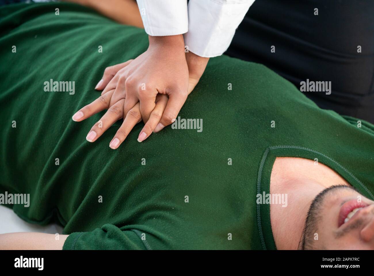 Rescuer hands doing emergency CPR on heart attacked man trying to save ...