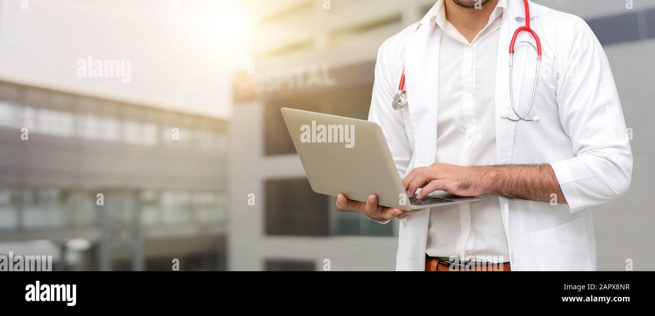 Doctor using laptop computer at the hospital. Medical healthcare and ...