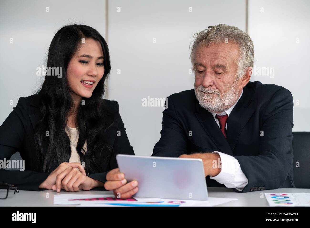 Senior executive manager and young businesswoman working in meeting ...