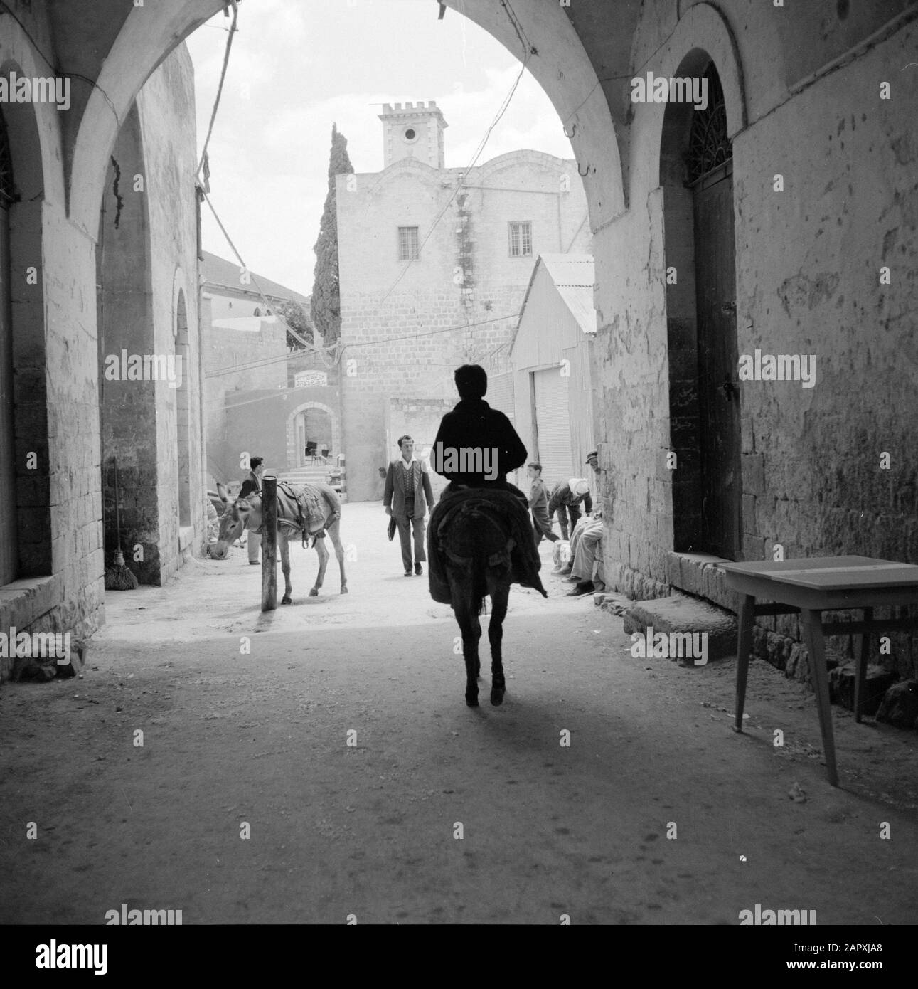 Israel: Nazareth Street with passers-by and donkeys seen from under a ...